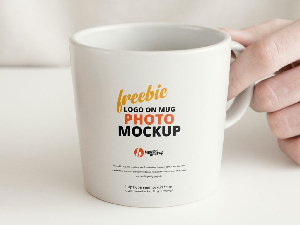 Free Person Holding Mug Logo Mockup Design - Mockup Planet